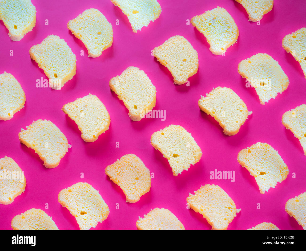 Slice cake pattern on strong pink background Stock Photo - Alamy