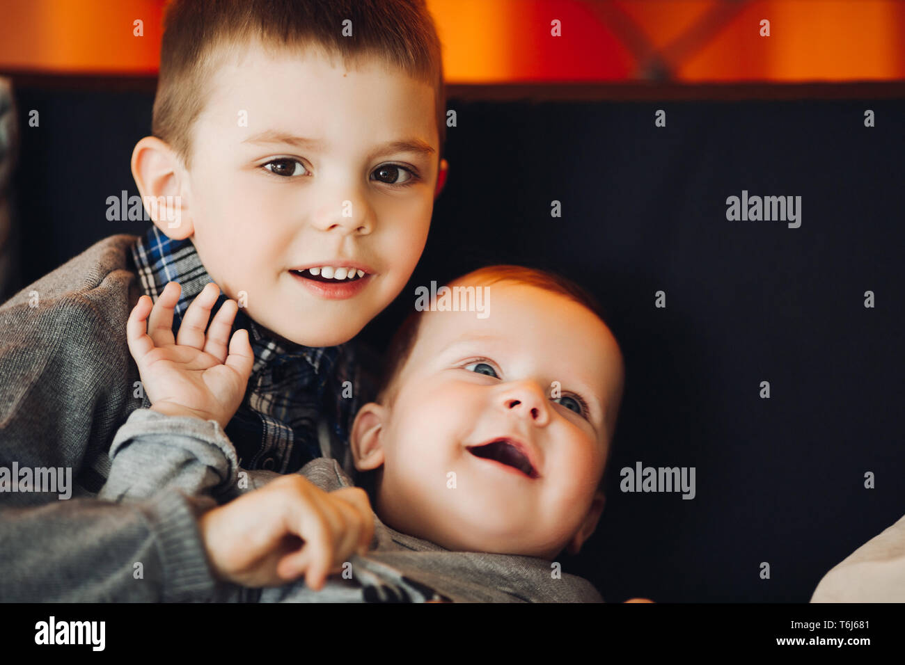 Happy boy embracing his little little brother Stock Photo - Alamy