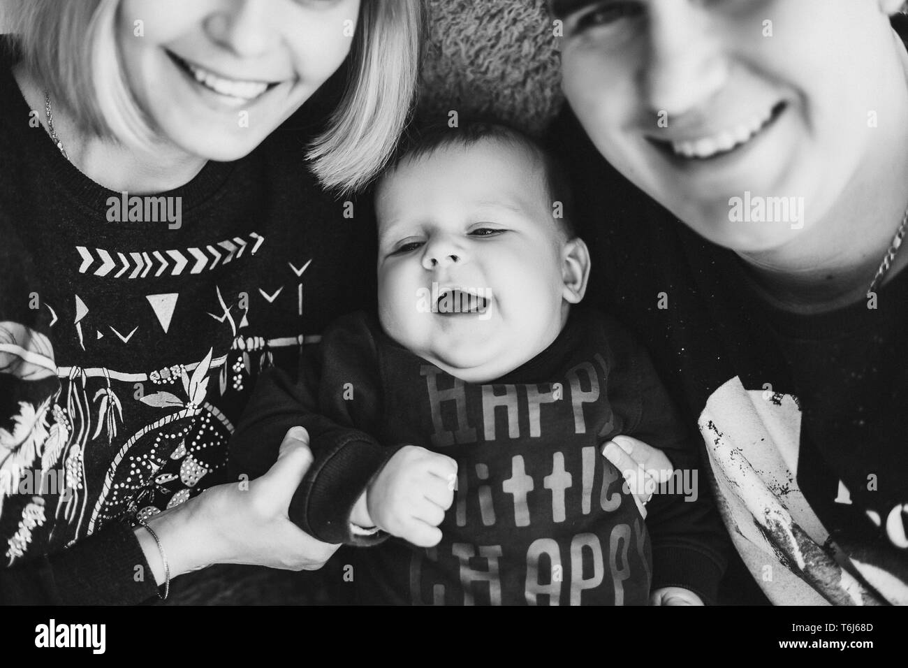 Happy boy smiling and playing together with parents Stock Photo - Alamy
