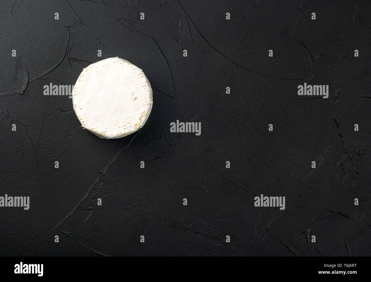 Round brie cheese with mold on dark concrete background, top view Stock ...