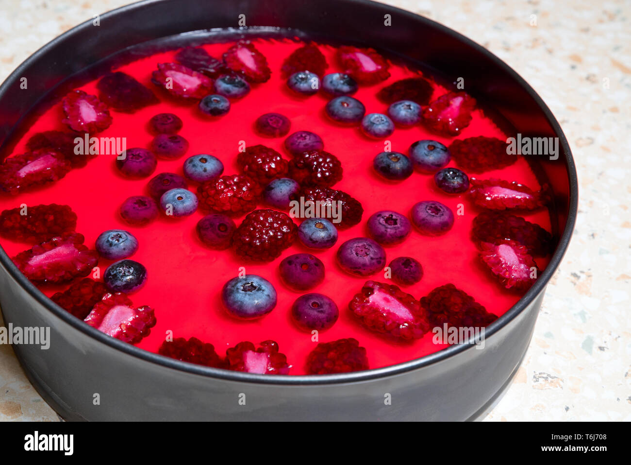 Red cheesecake with wild berries Stock Photo - Alamy