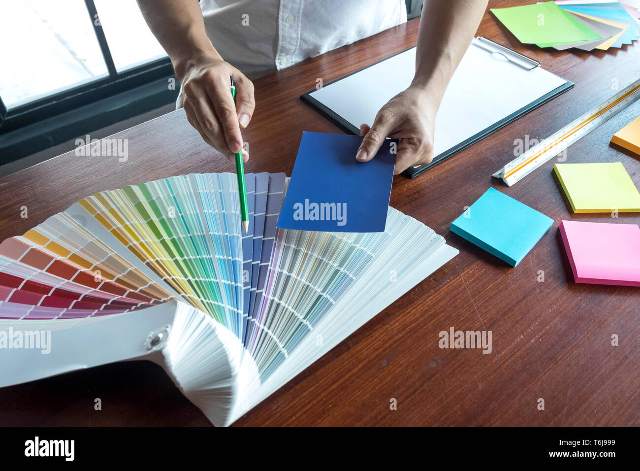 Graphic designer choose colors from the color bands samples for design ...