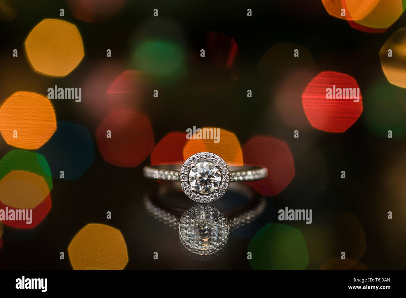 Engagement ring with a reflection of bokeh lights Stock Photo - Alamy