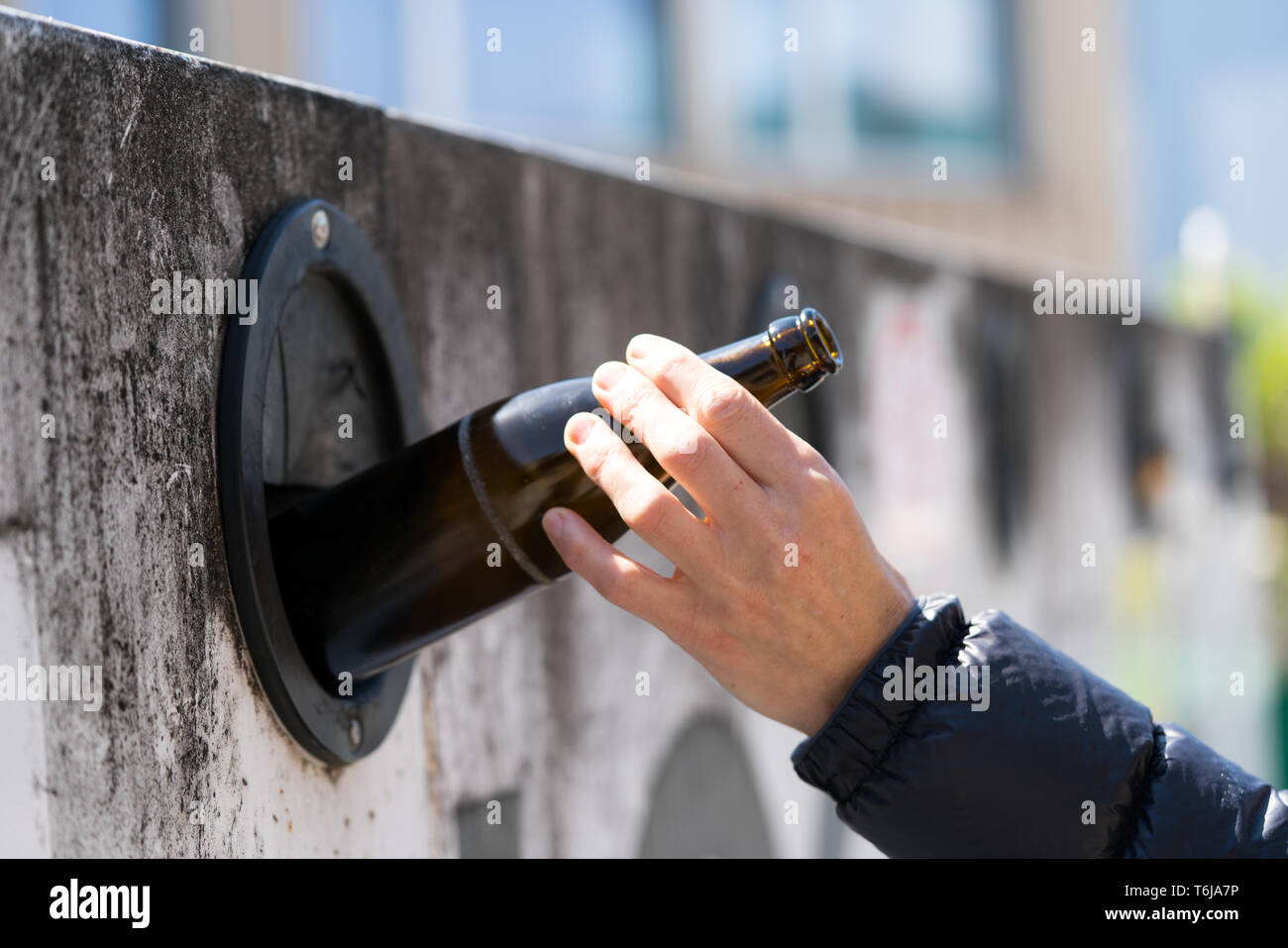 detail view of a female hand recycling glass to save the environment at ...