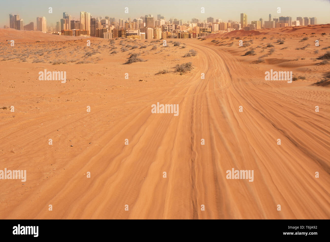 Track in the desert that leads to the big city Stock Photo - Alamy
