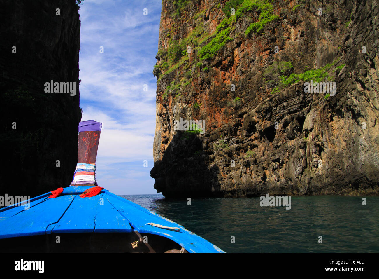 View on blue decorated wooden bow of longtail boat and passage between ...