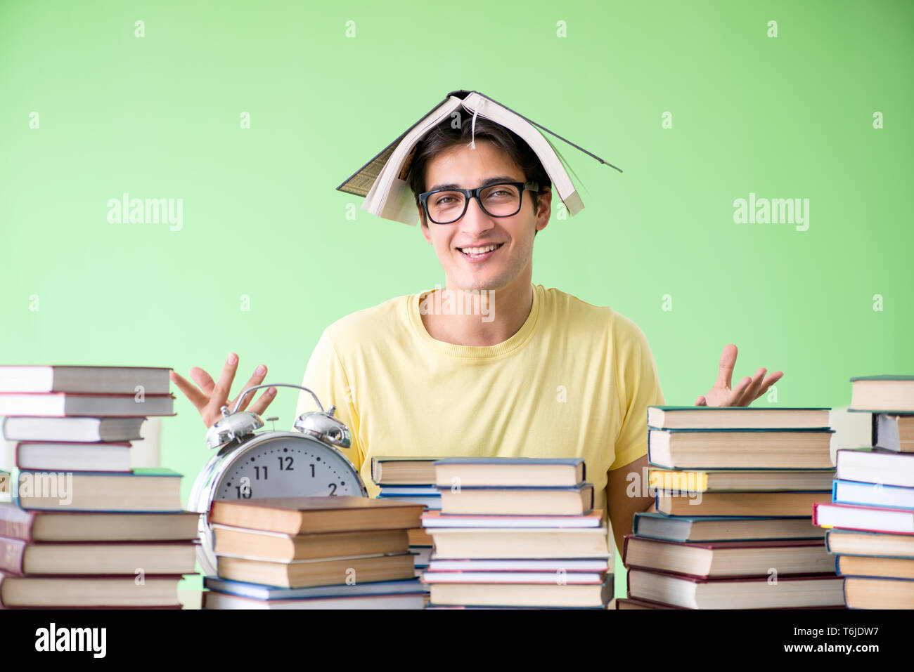 Student with too many books to read before exam Stock Photo - Alamy