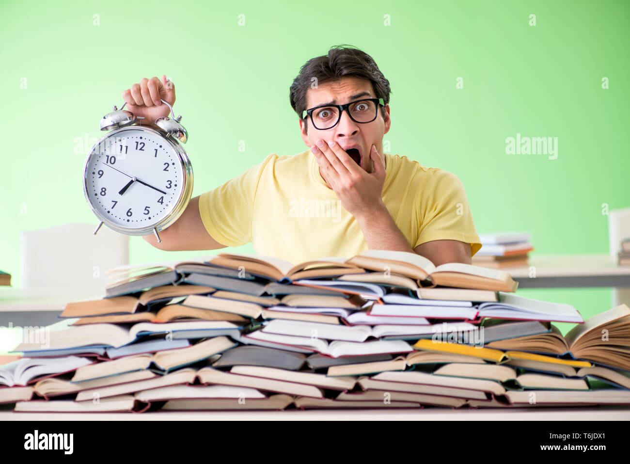 Student with too many books to read before exam Stock Photo - Alamy