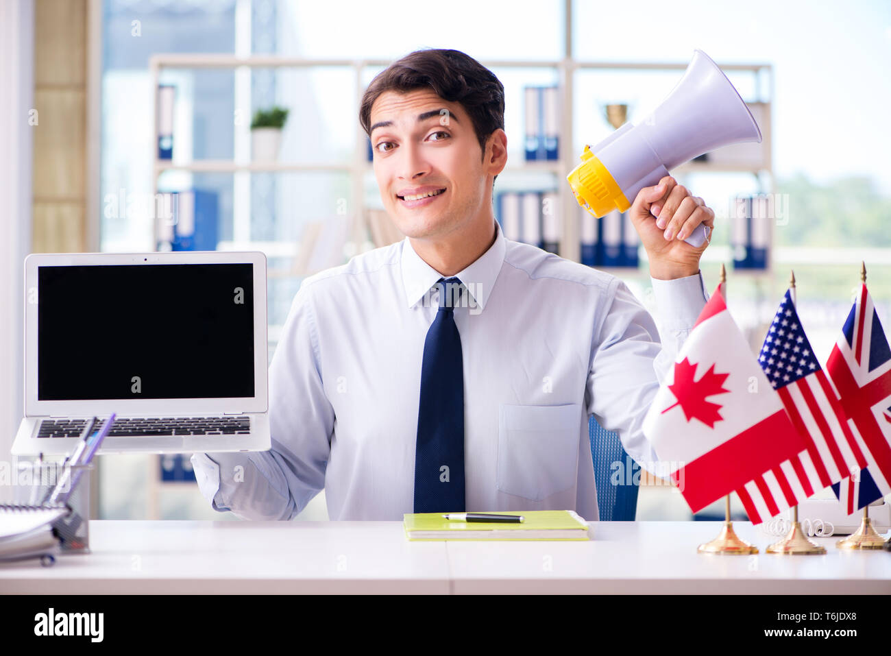 Sales agent working in travel agency Stock Photo - Alamy