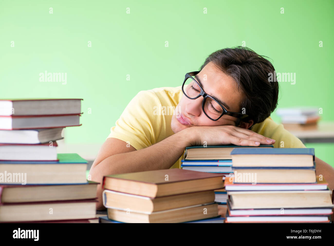 Student with too many books to read before exam Stock Photo - Alamy