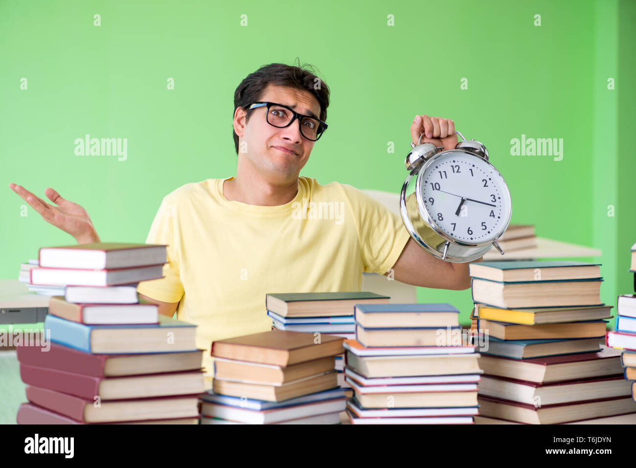 Student with too many books to read before exam Stock Photo - Alamy