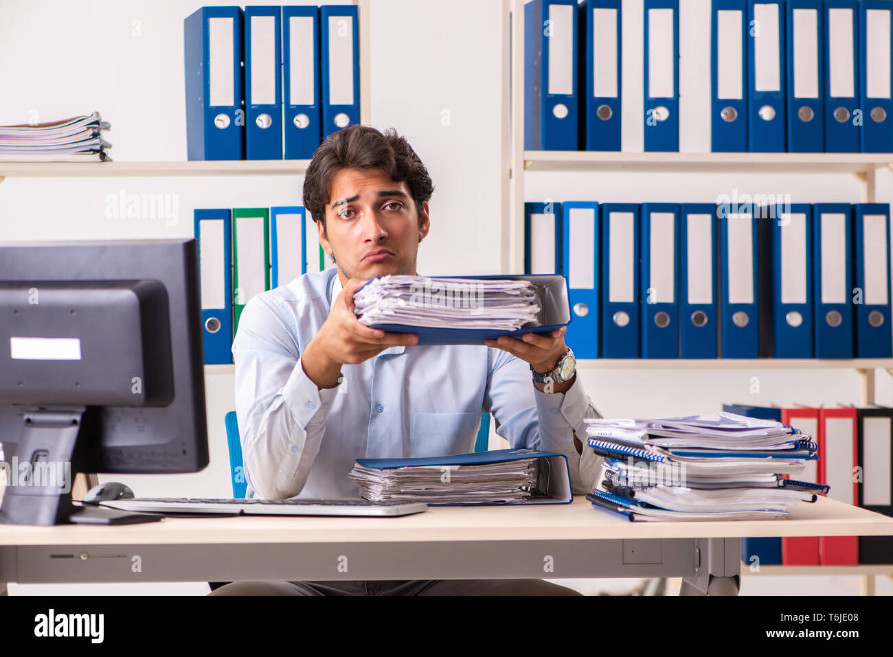 Overloaded busy employee with too much work and paperwork Stock Photo ...