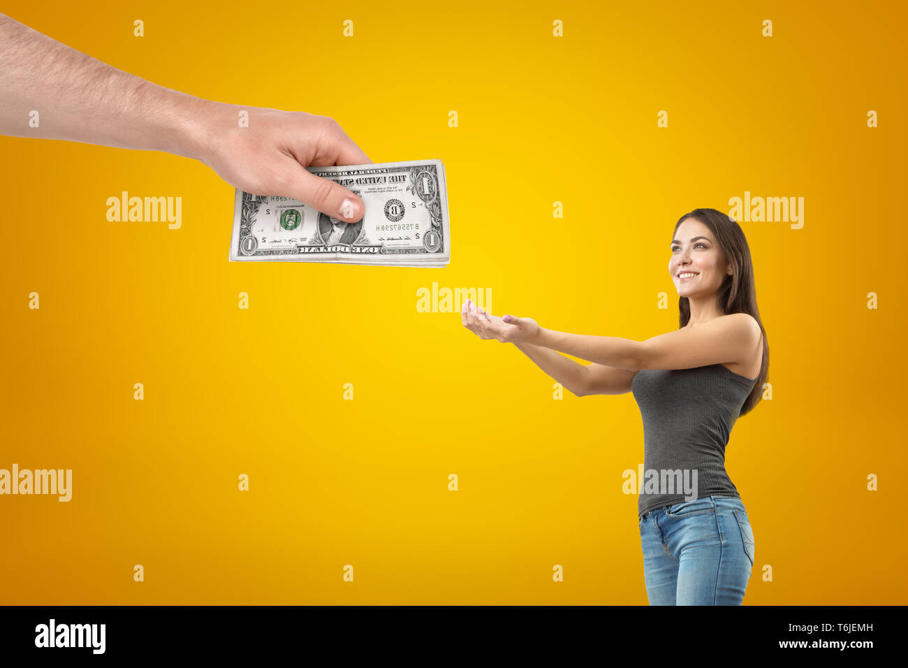 Side crop view of young pretty girl in casual clothes holding out hands ...