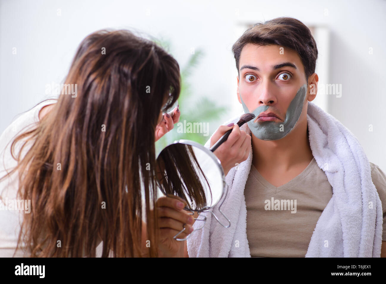 Handsome applying clay mask on face Stock Photo - Alamy