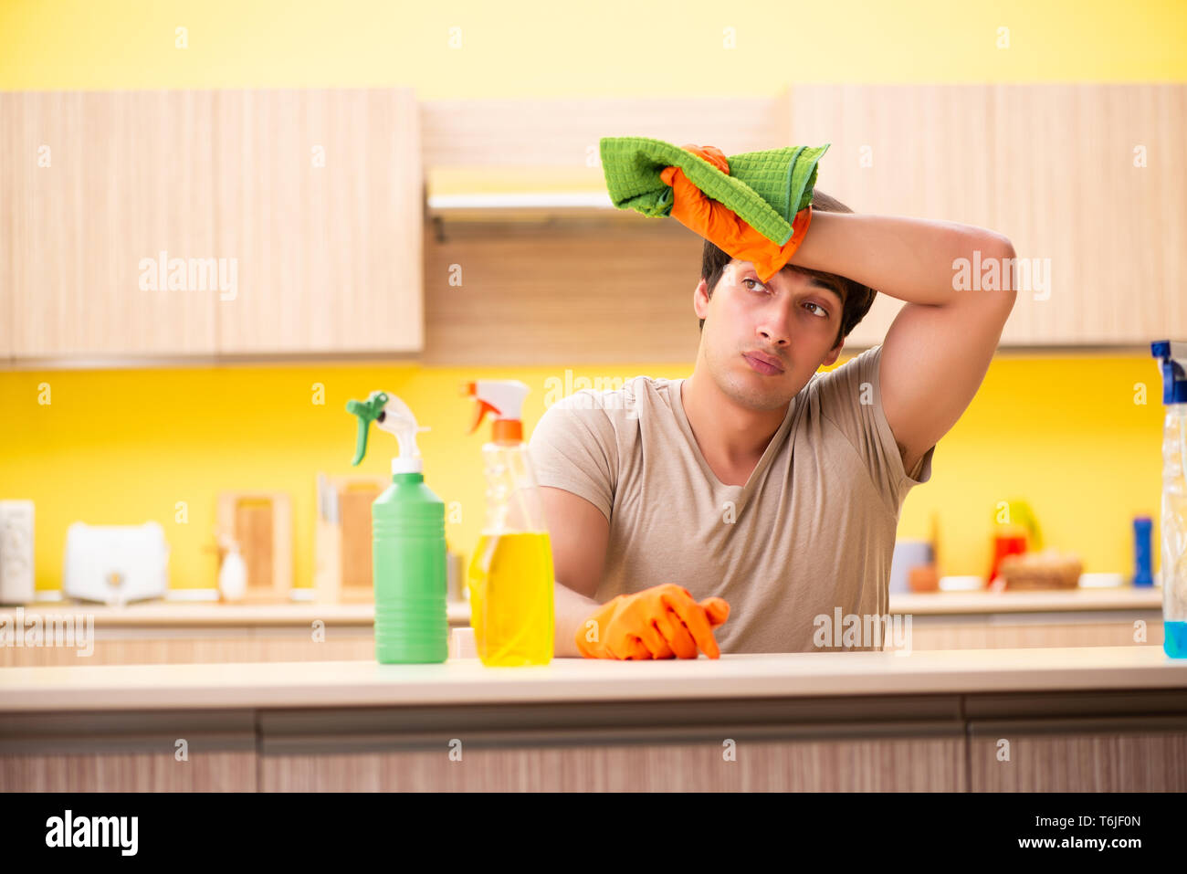 Single man cleaning kitchen at home Stock Photo - Alamy