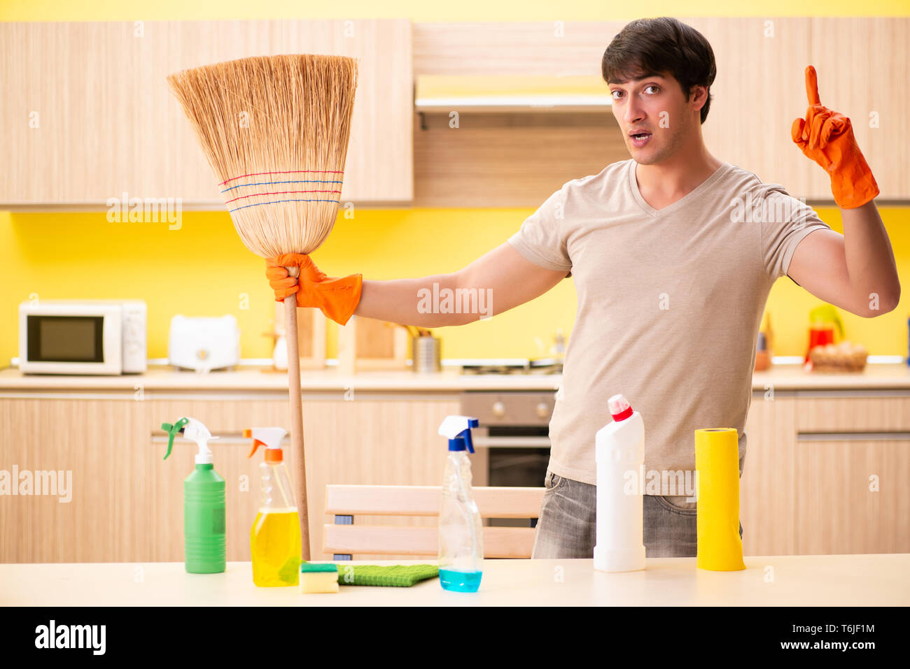 Single man cleaning kitchen at home Stock Photo - Alamy