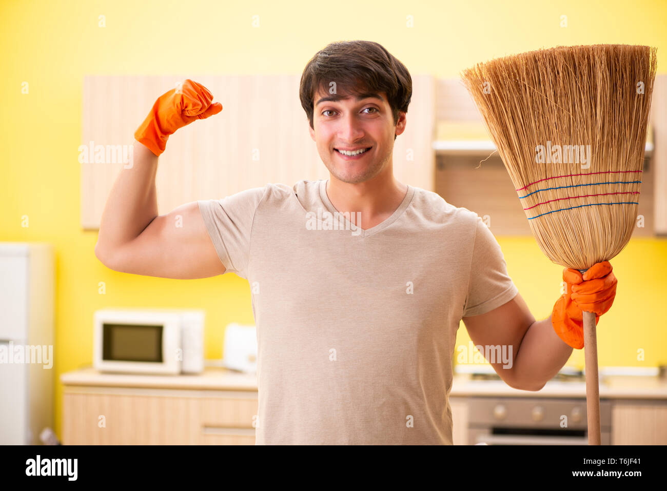 Single man cleaning kitchen at home Stock Photo - Alamy