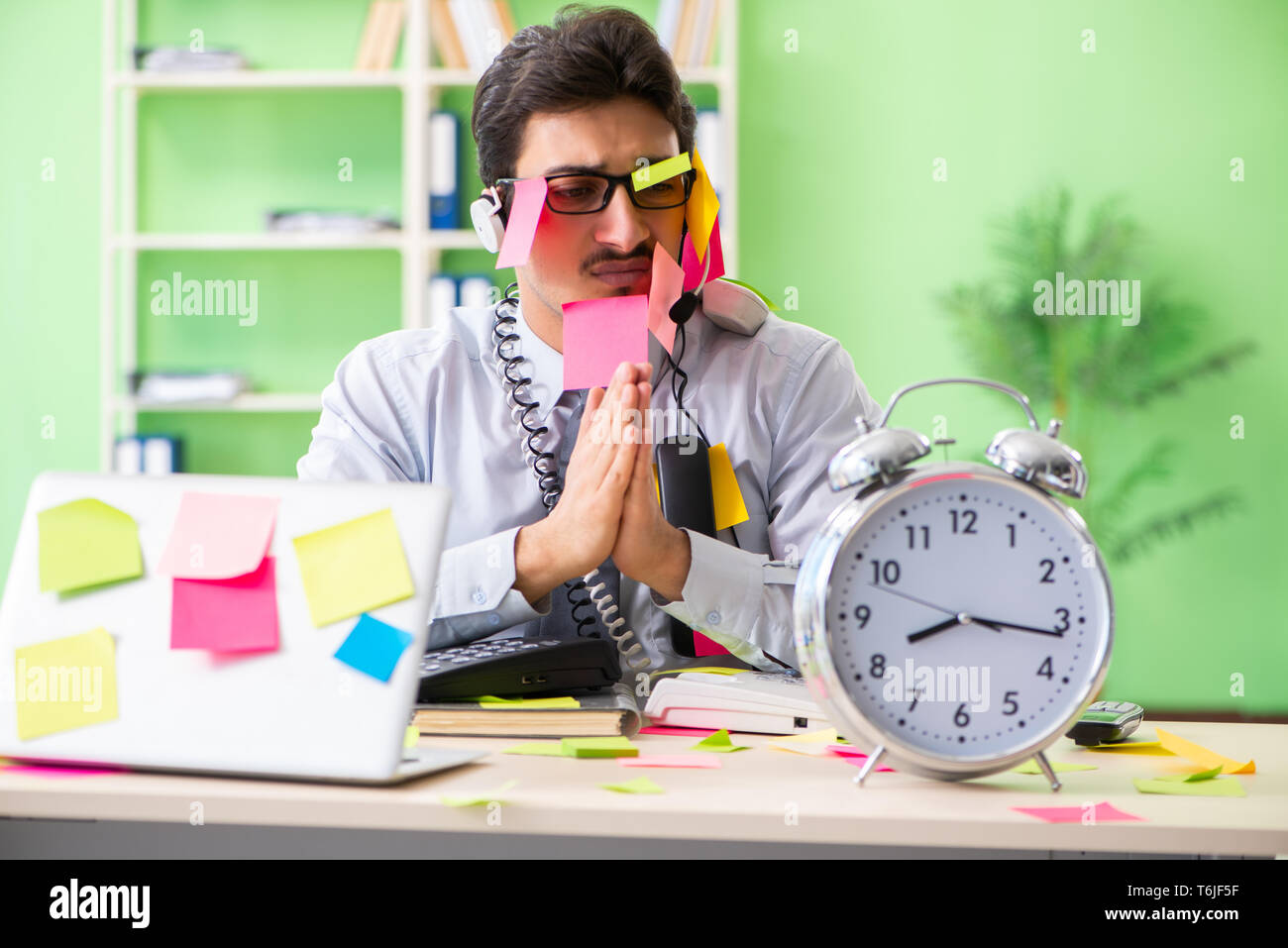 Young help desk operator working in office with many conflicting Stock ...