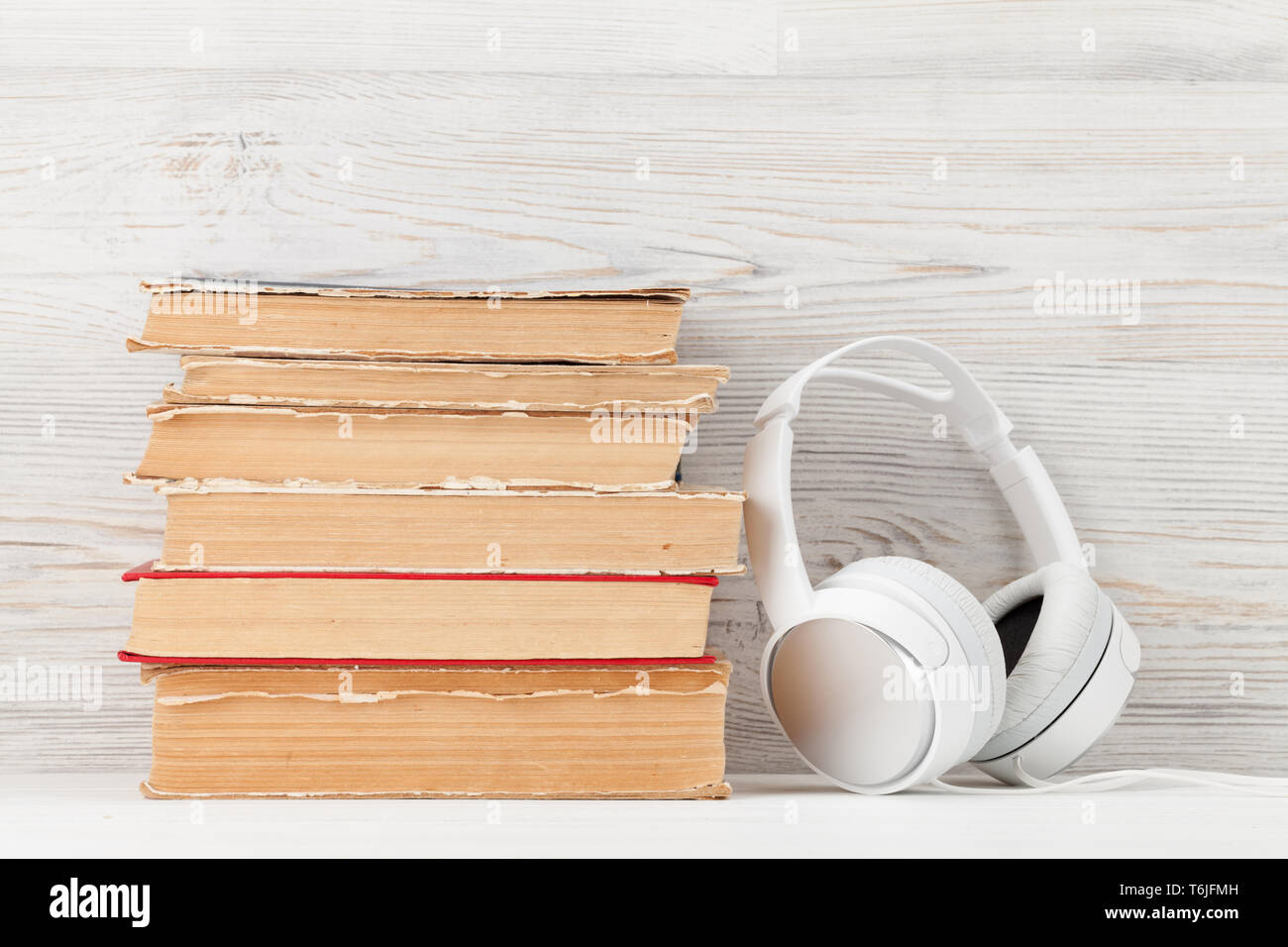 Home office workplace with stack of old books and headphones. With copy ...