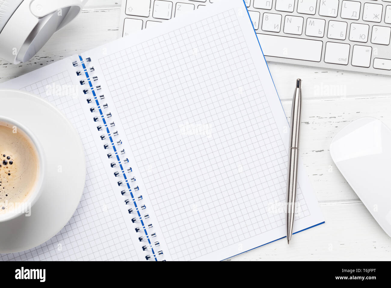 Office workplace table with notepad, coffee cup, supplies and laptop ...