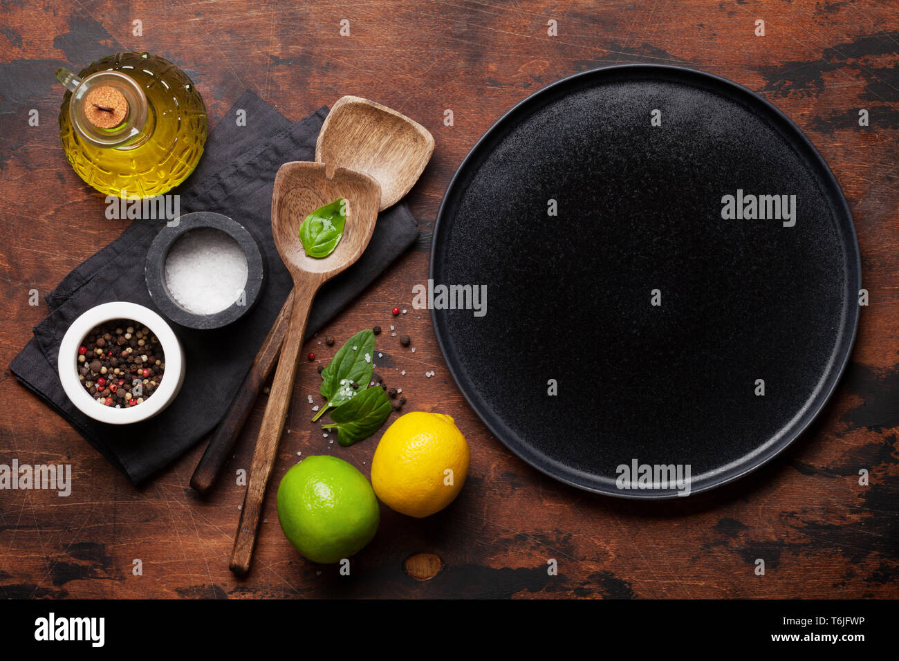 Cooking wooden utensils, condiments and spices on wooden kitchen table ...