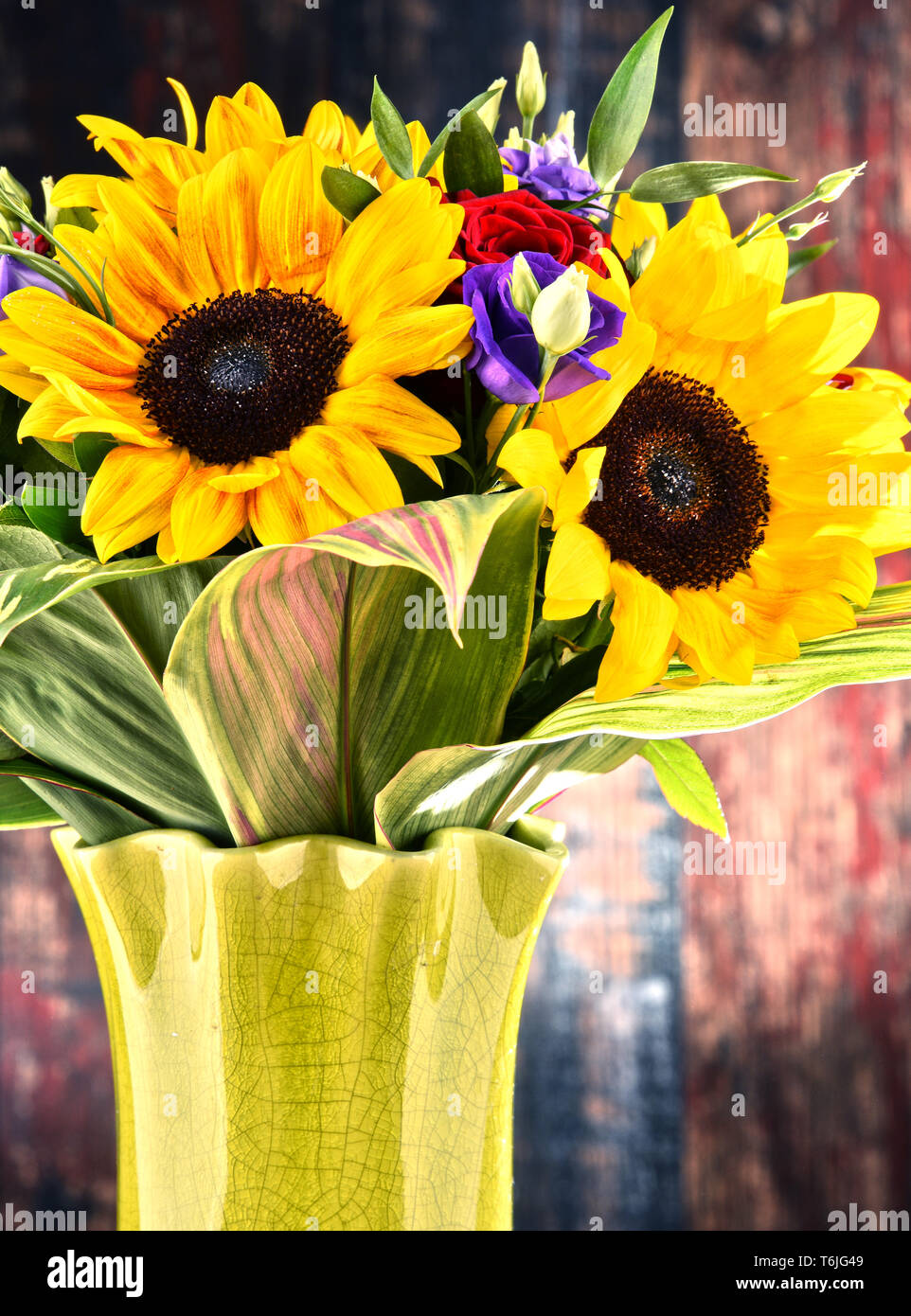 Composition with bouquet of flowers including sunflowers and roses ...