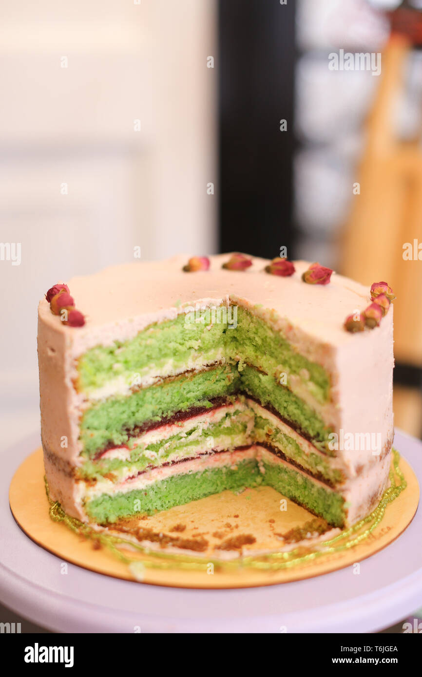 Yummy green multicolored cake for birthday party Stock Photo - Alamy