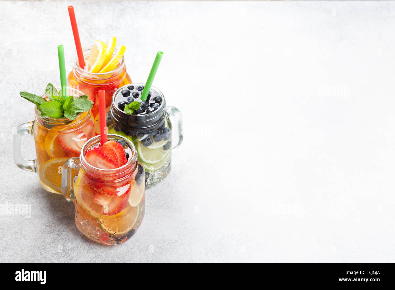 Fresh lemonade jar with summer fruits and berries. With space for your ...