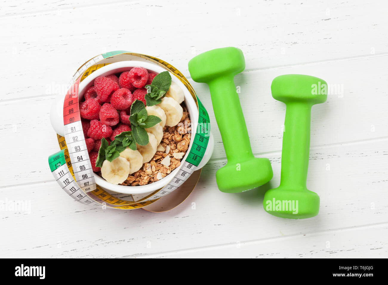 Healthy food and fitness concept. Breakfast cereal and sport equipment ...