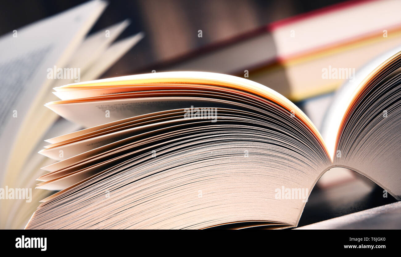 Composition with open book on the table Stock Photo - Alamy