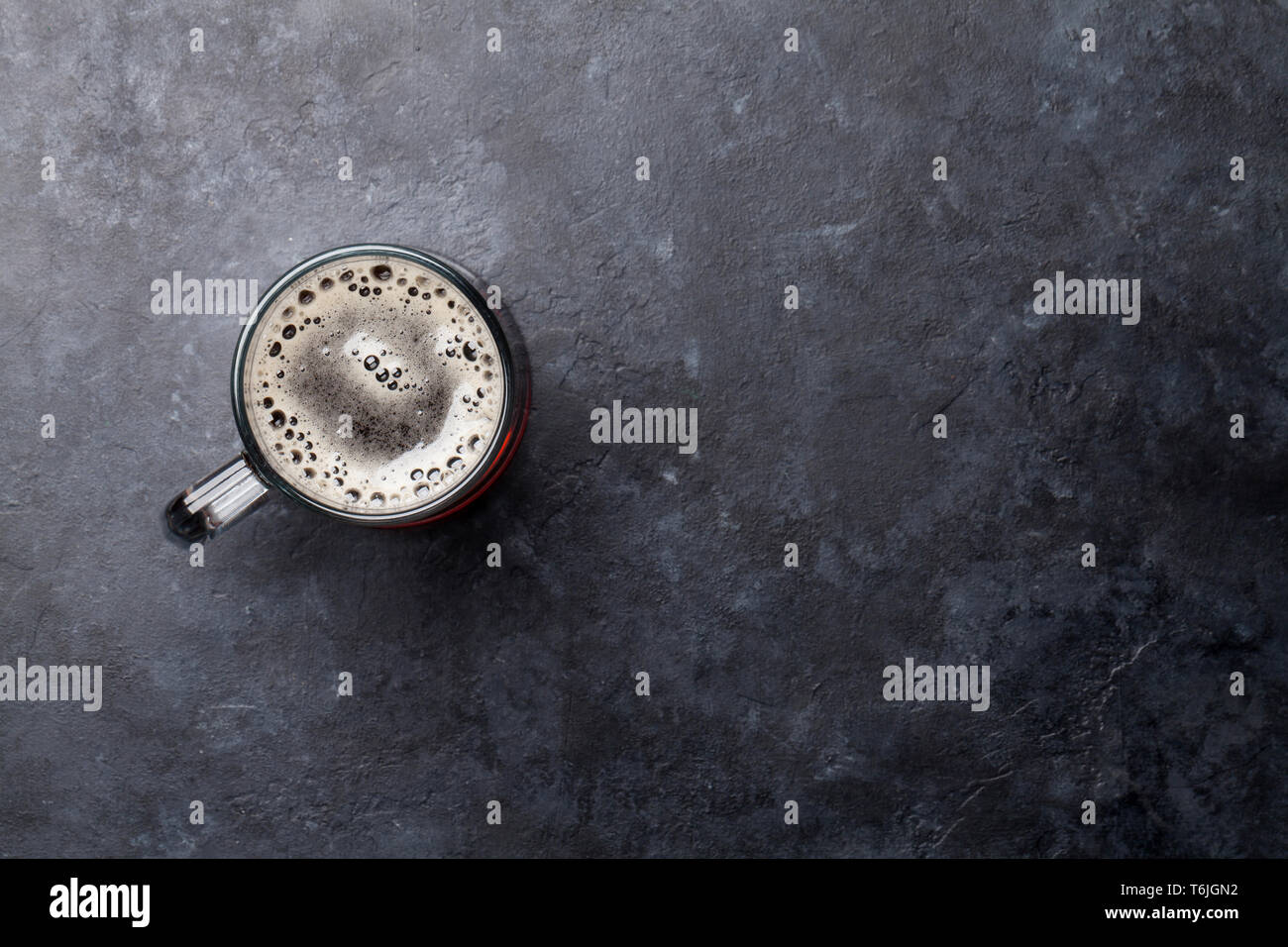 Glass of dark porter beer on stone table. Top view flat lay with copy ...