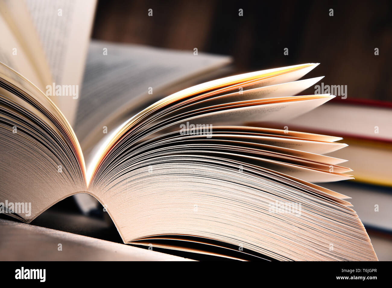 Composition with open book on the table Stock Photo - Alamy