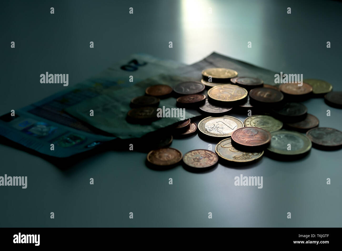 Money never sleeps. Cash at moonlight, euro banknotes, and coins on the ...