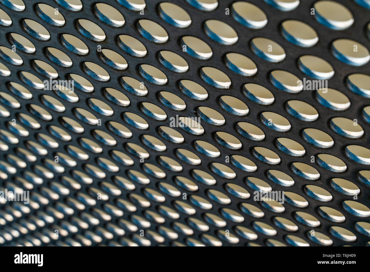 Metal hole mesh pattern with shallow depth of focus background Stock ...