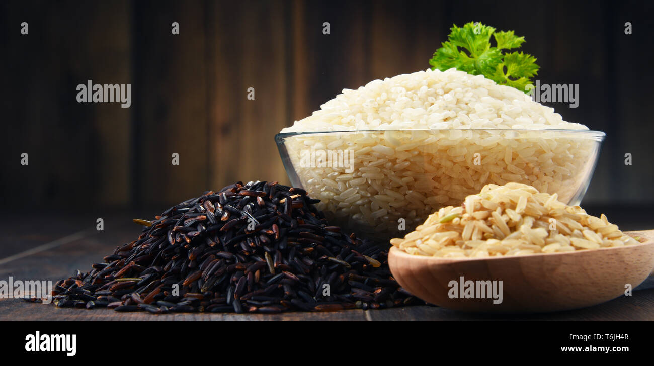 Composition with bowl of rice on wooden table Stock Photo - Alamy