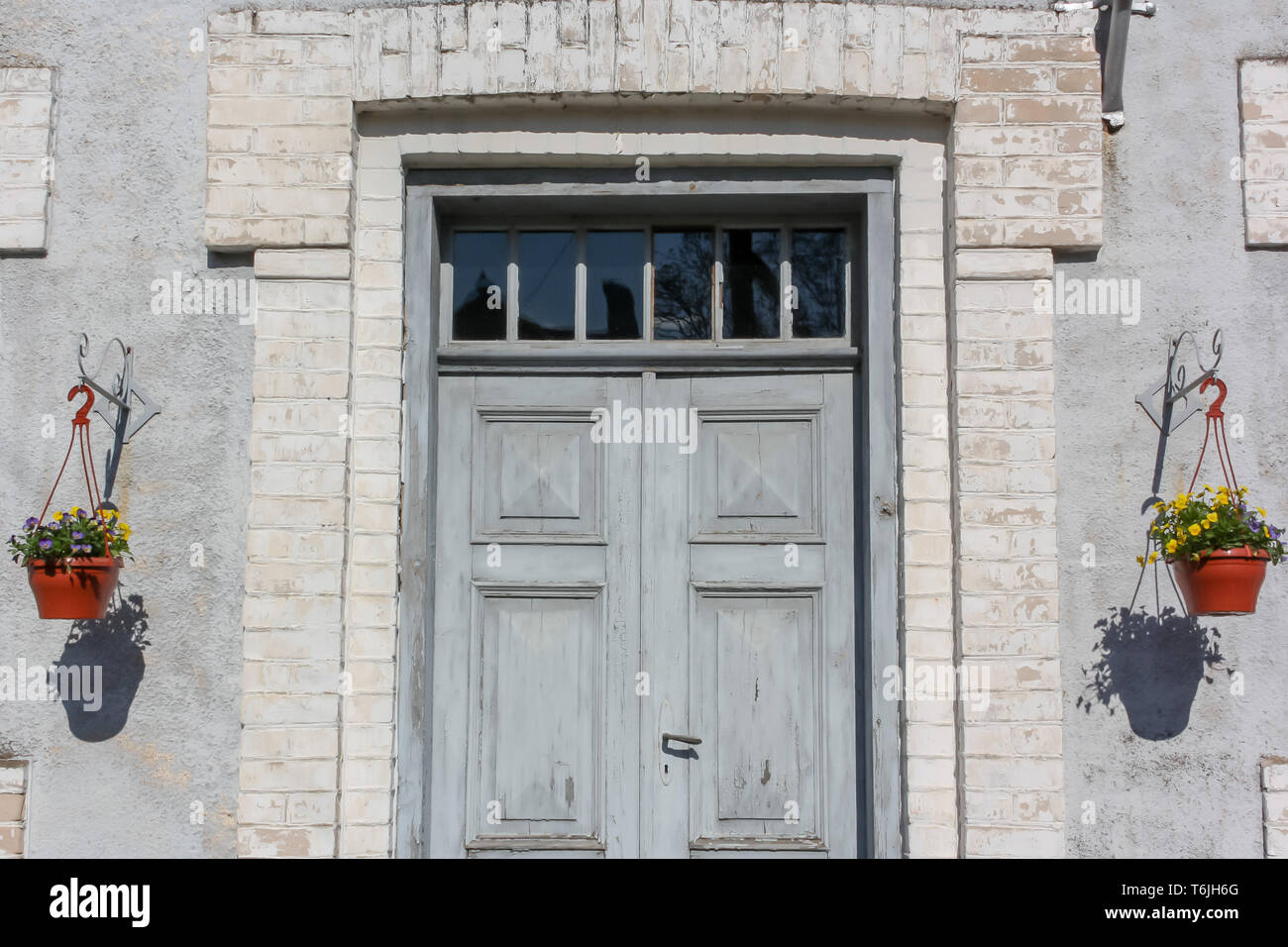 The rustic front door of an old cottage with vintage hardware and ...