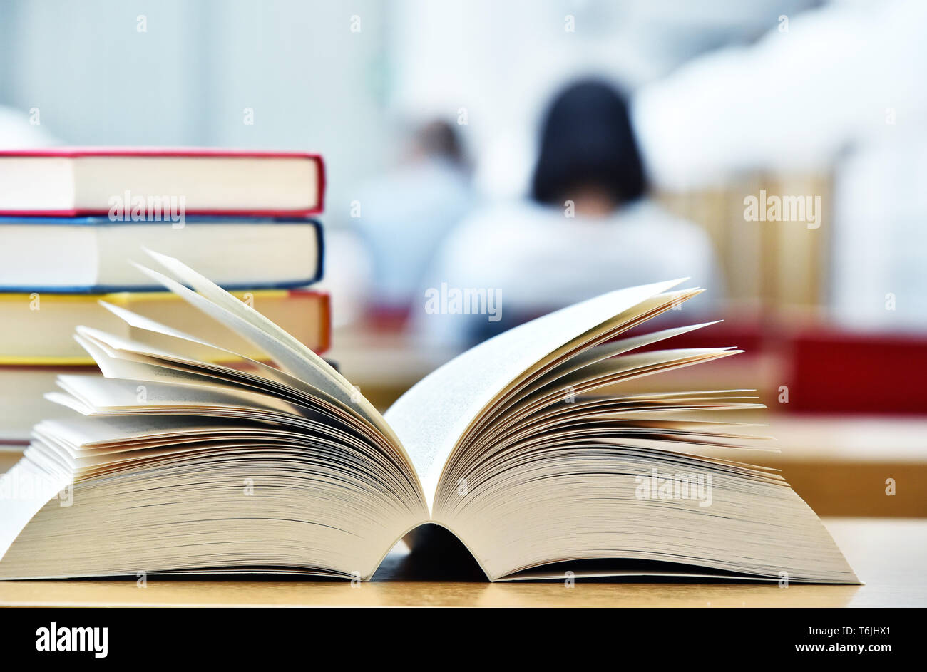 Books lying on the table in the public library Stock Photo - Alamy