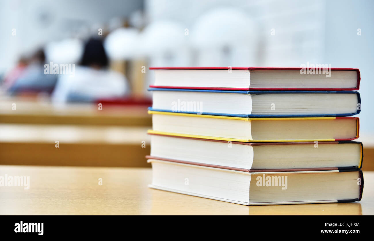 Books lying on the table in the public library Stock Photo - Alamy