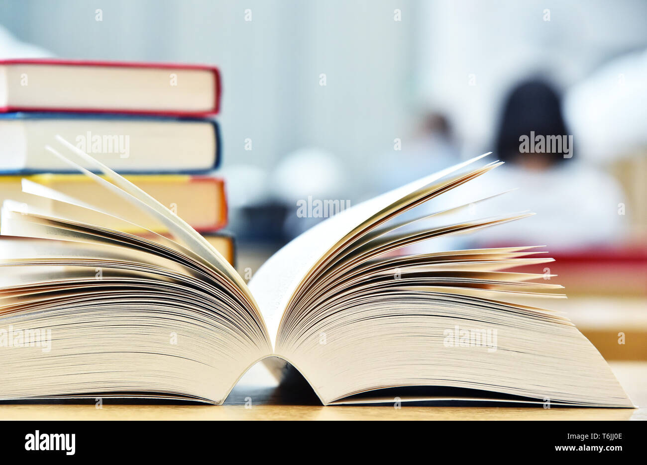 Books lying on the table in the public library Stock Photo - Alamy