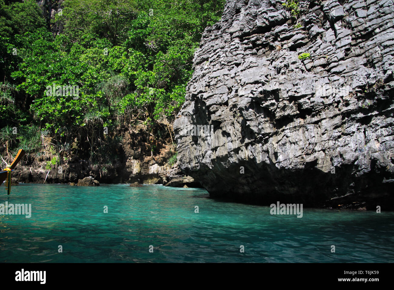 Boat trip into bay with impressive cliff and turquoise water around ...