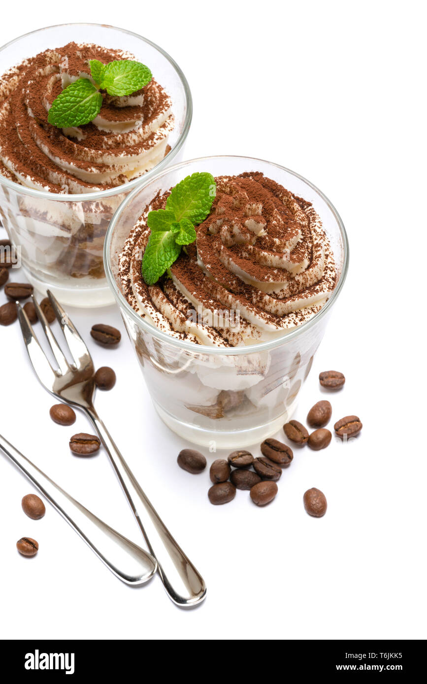 two portions Classic tiramisu dessert in a glass isolated on a white ...