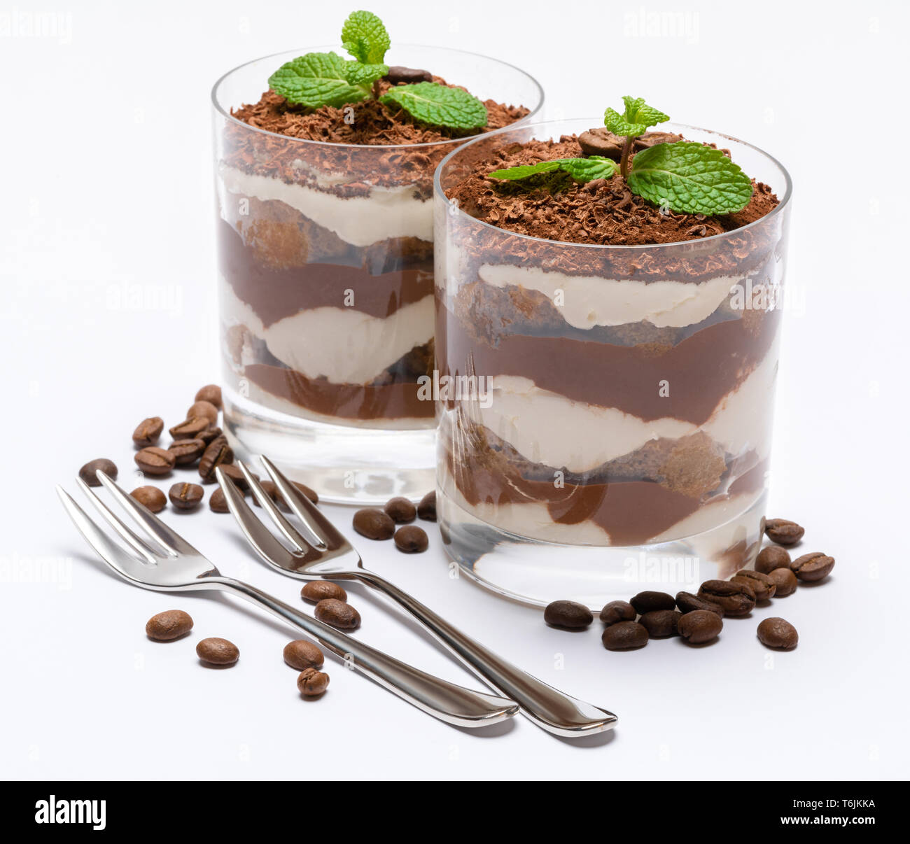 two portions Classic tiramisu dessert in a glass isolated on a white ...