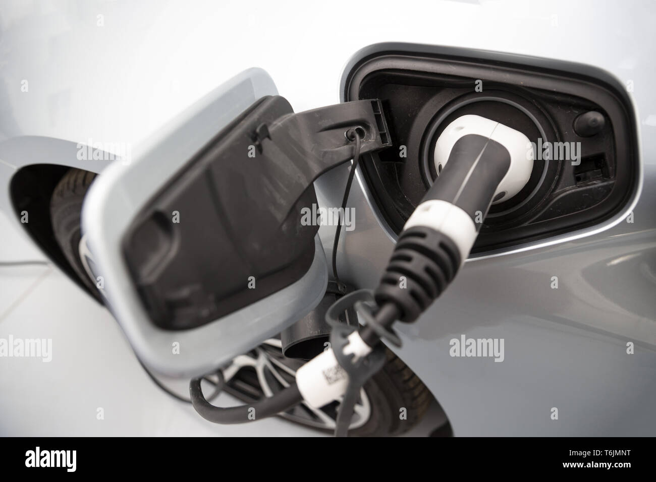 Electric car being charged Stock Photo - Alamy