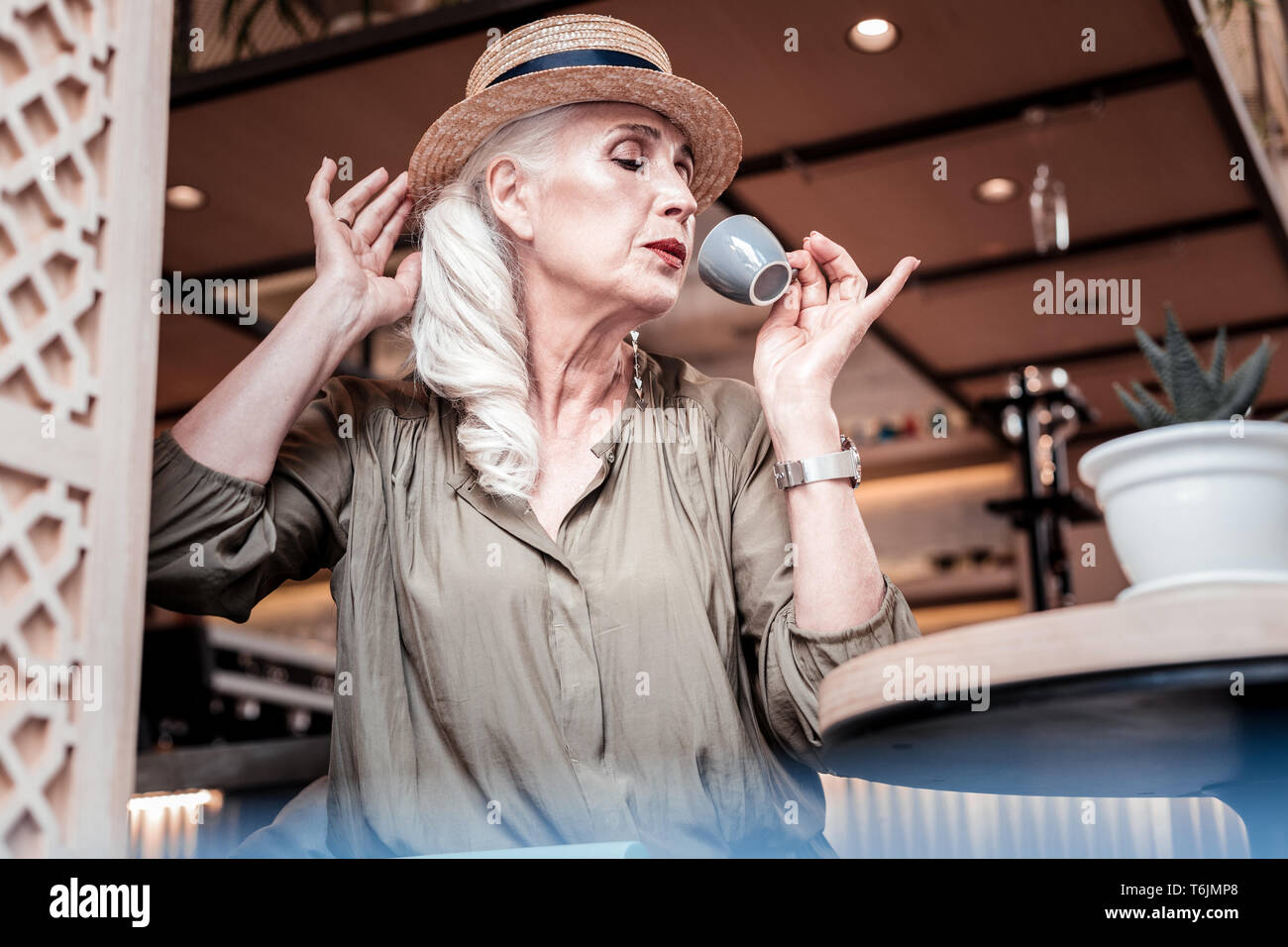 Appealing well maintained long-haired lady in straw hat Stock Photo - Alamy