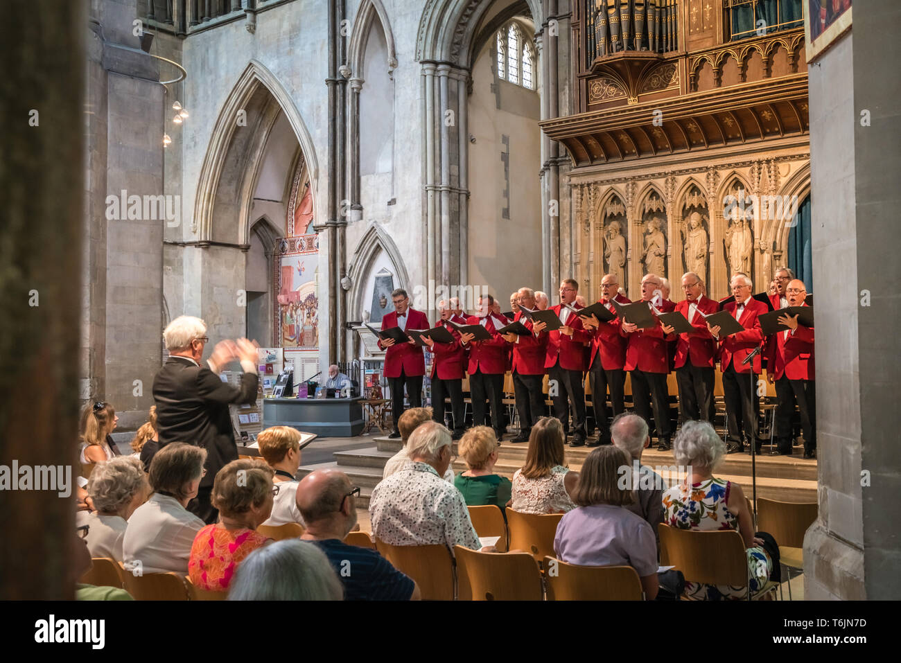 Mens choir performing in a cathedral Stock Photo - Alamy