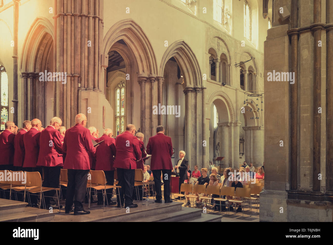 Mens choir performing in a cathedral Stock Photo - Alamy