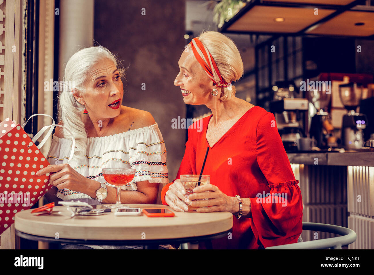 Elegant good-looking short-haired woman talking to her friend Stock ...