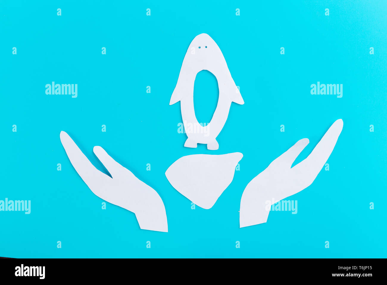 save penguins concept. hands protect penguin Stock Photo - Alamy