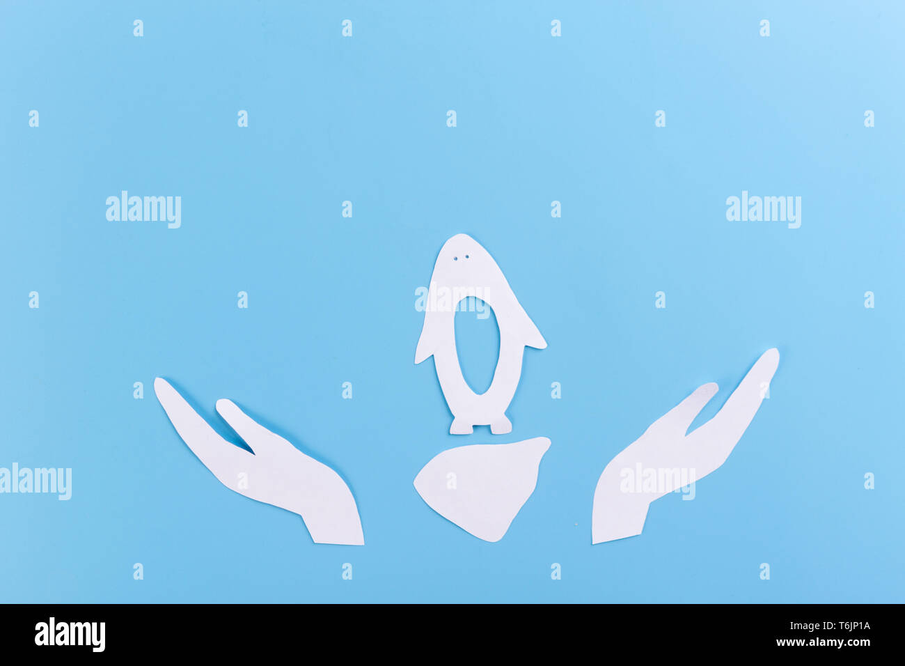 save penguins concept. hands protect penguin Stock Photo - Alamy