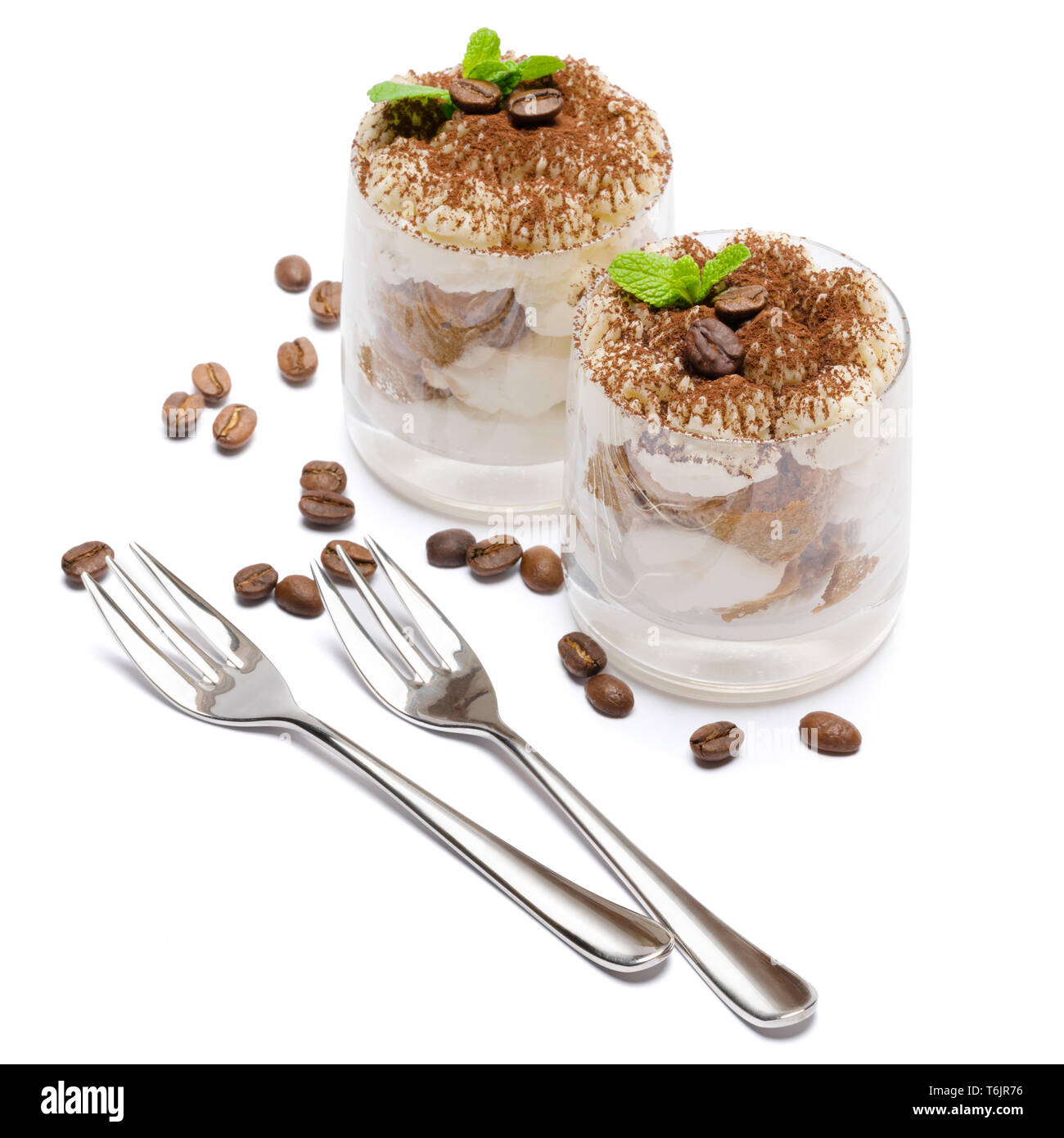 two portions Classic tiramisu dessert in a glass isolated on a white ...